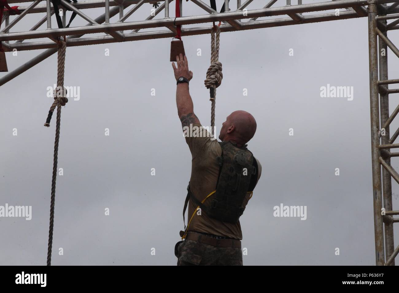 A U.S. Army Ranger completes the rope climb at the Spartan Race during ...