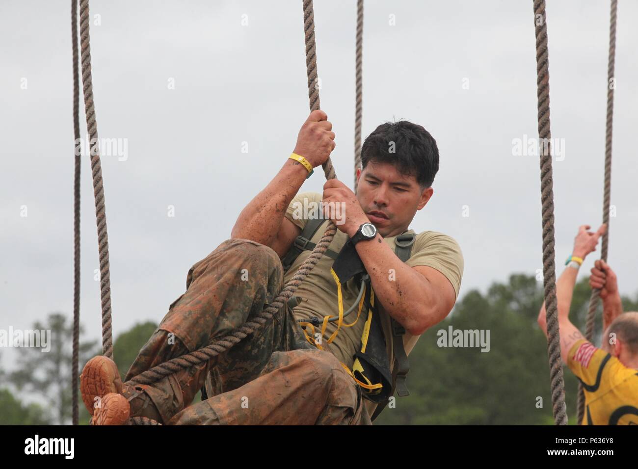 A U.S. Army Ranger climbs a rope at the Spartan Race during the Best ...