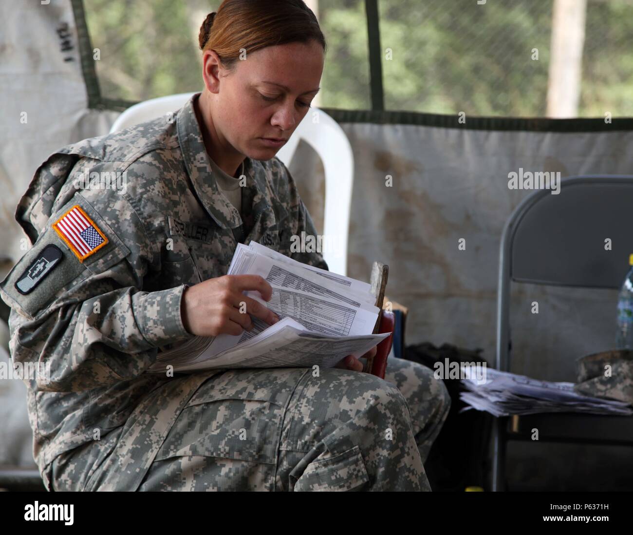 U.S. Army Ssg. Nicole Bottemiller takes a moment to document patients ...