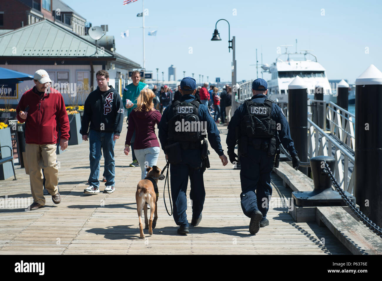 A Coast Guard K-9 unit patrols a pier along Boston’s waterfront, Sunday ...