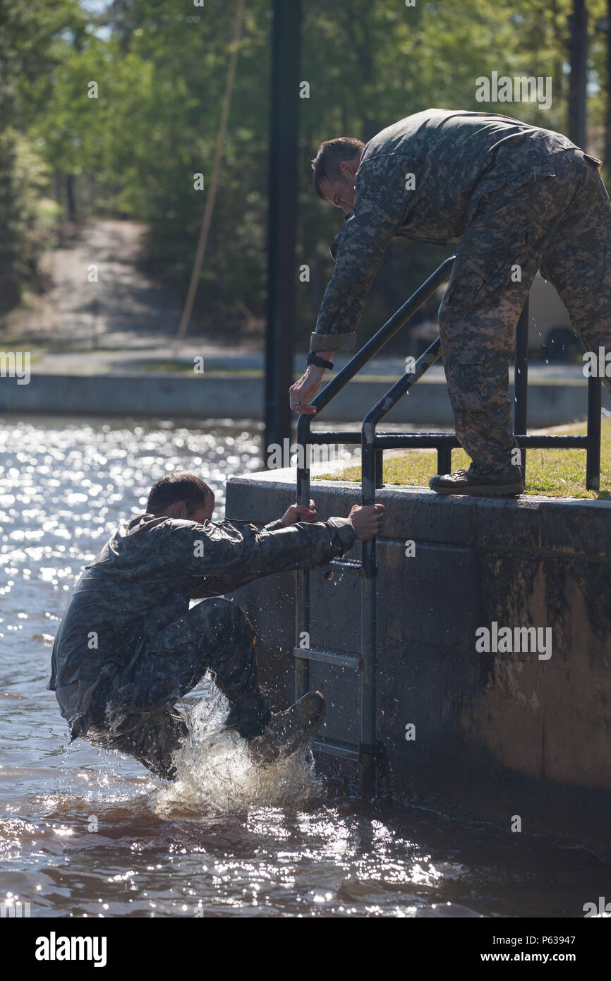 U.S. Army Capt. Bert Ferguson reaches out to assist his battle buddy ...