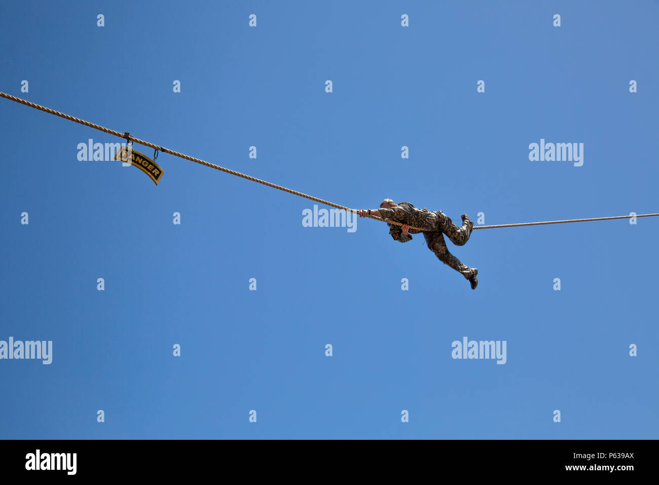 U.S. Army Ranger moves across a rope to touch the U.S. Army Ranger tab ...