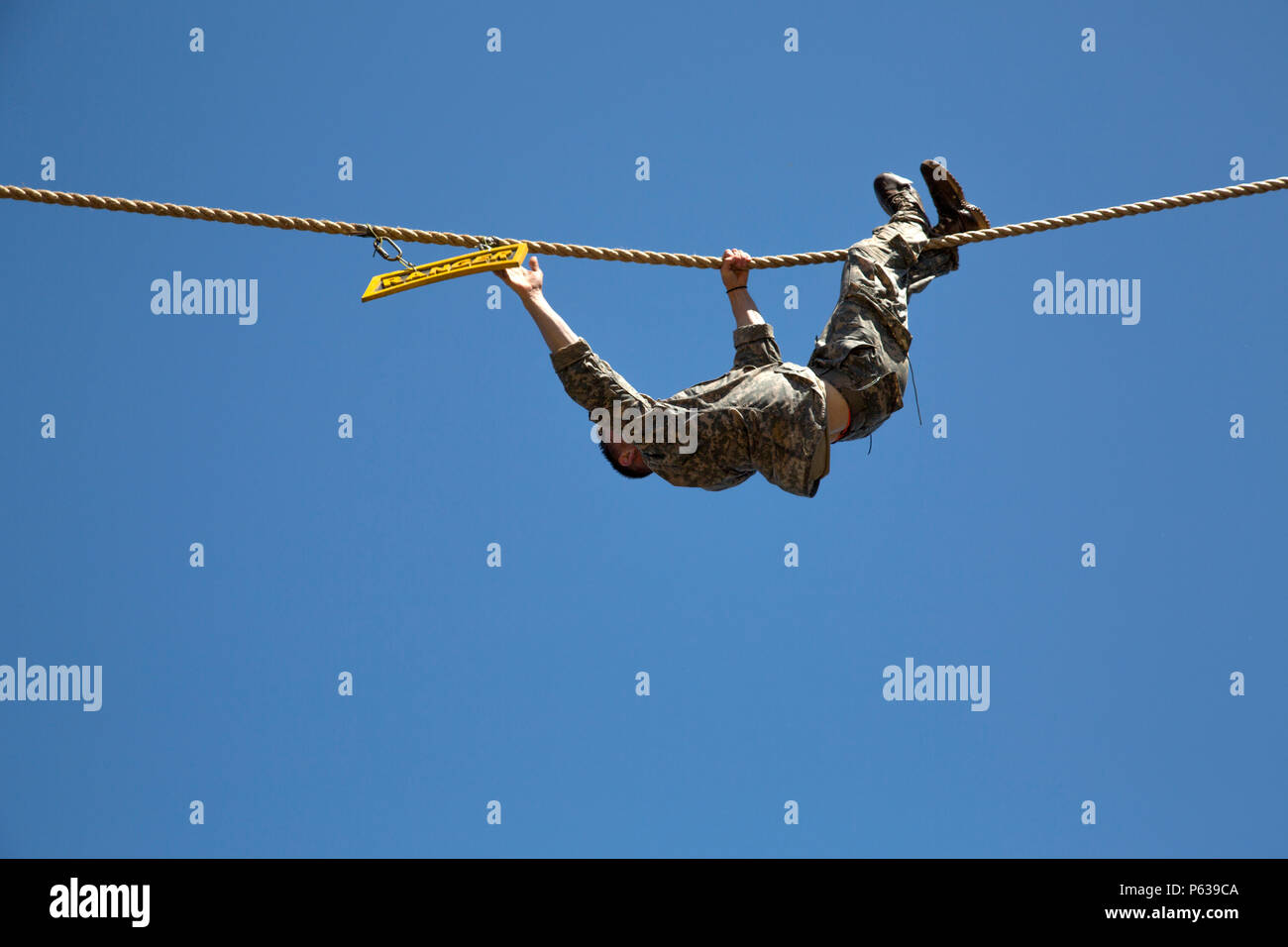 U.S. Army Ranger moves across a rope to touch the U.S. Army Ranger tab ...