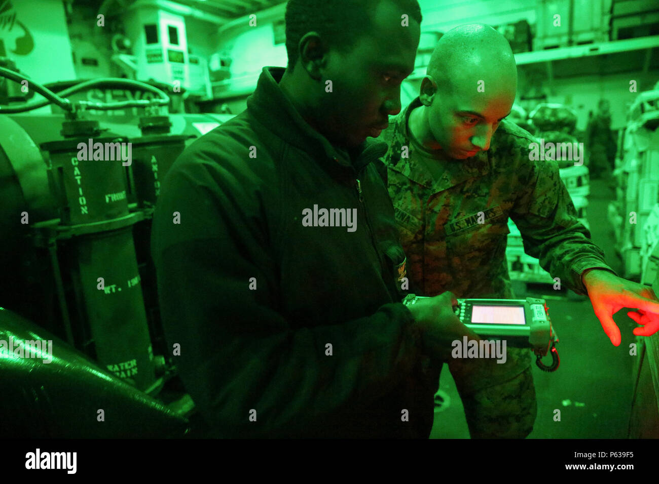 U.S. Marines and Sailors help each move supplies onto the USS WASP ...