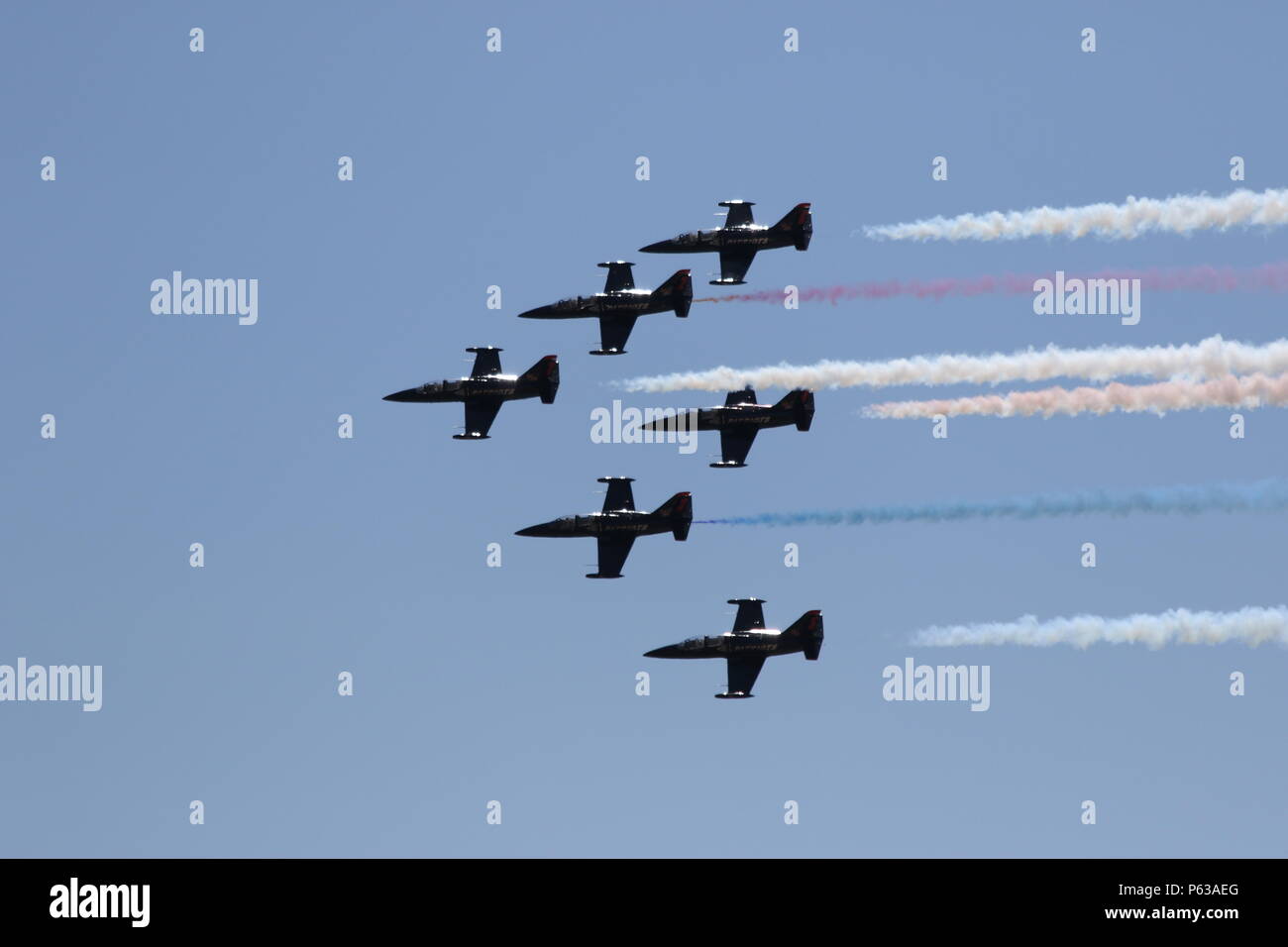 Members of the Patriots Jet Team fly in formation over the flight line ...