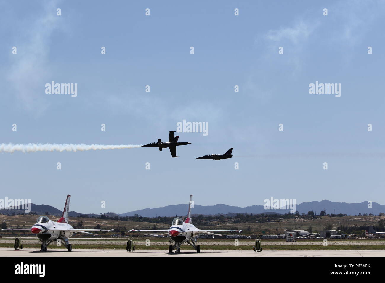 Members of the Patriots Jet Team perform maneuvers over the flight line ...