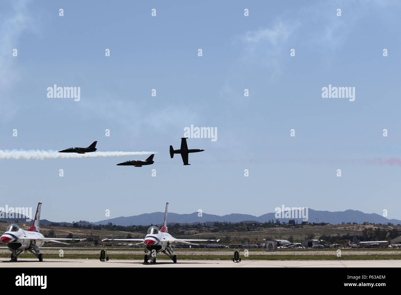 Members of the Patriots Jet Team perform maneuvers over the flight line ...