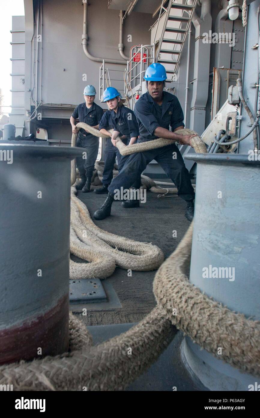 160418-N-BH414-063 ATLANTIC OCEAN (April 18, 2016) - Sailors heave in mooring lines during a sea ...