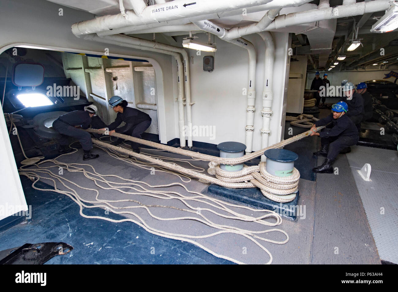 160418-N-KK394-048 ATLANTIC OCEAN (April 18, 2016) - Sailors heave in mooring lines during a sea ...