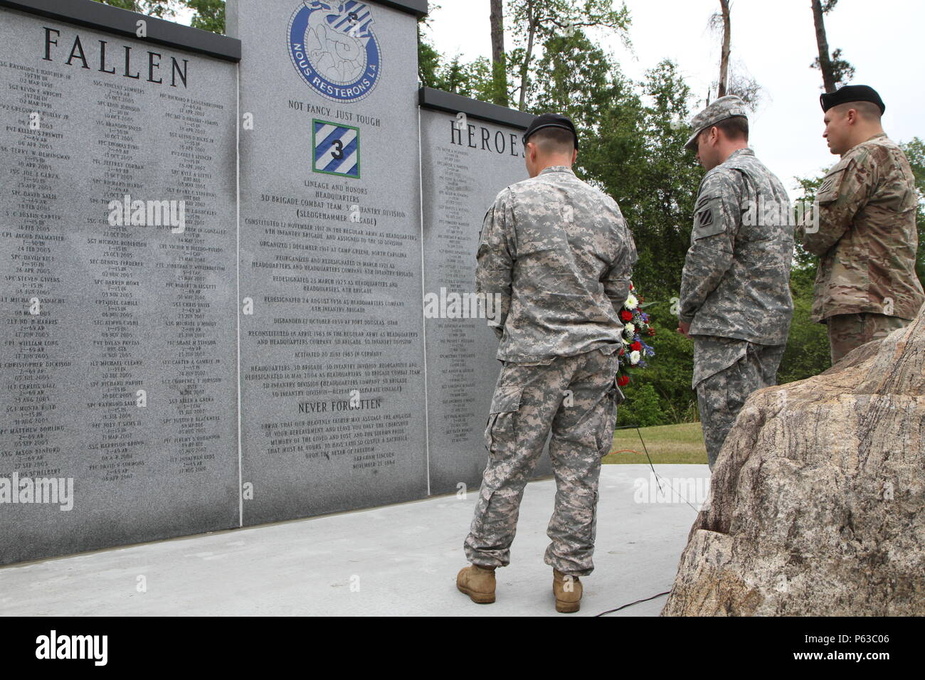 Soldiers spend a moment viewing the new Fallen Heroes Memorial ...