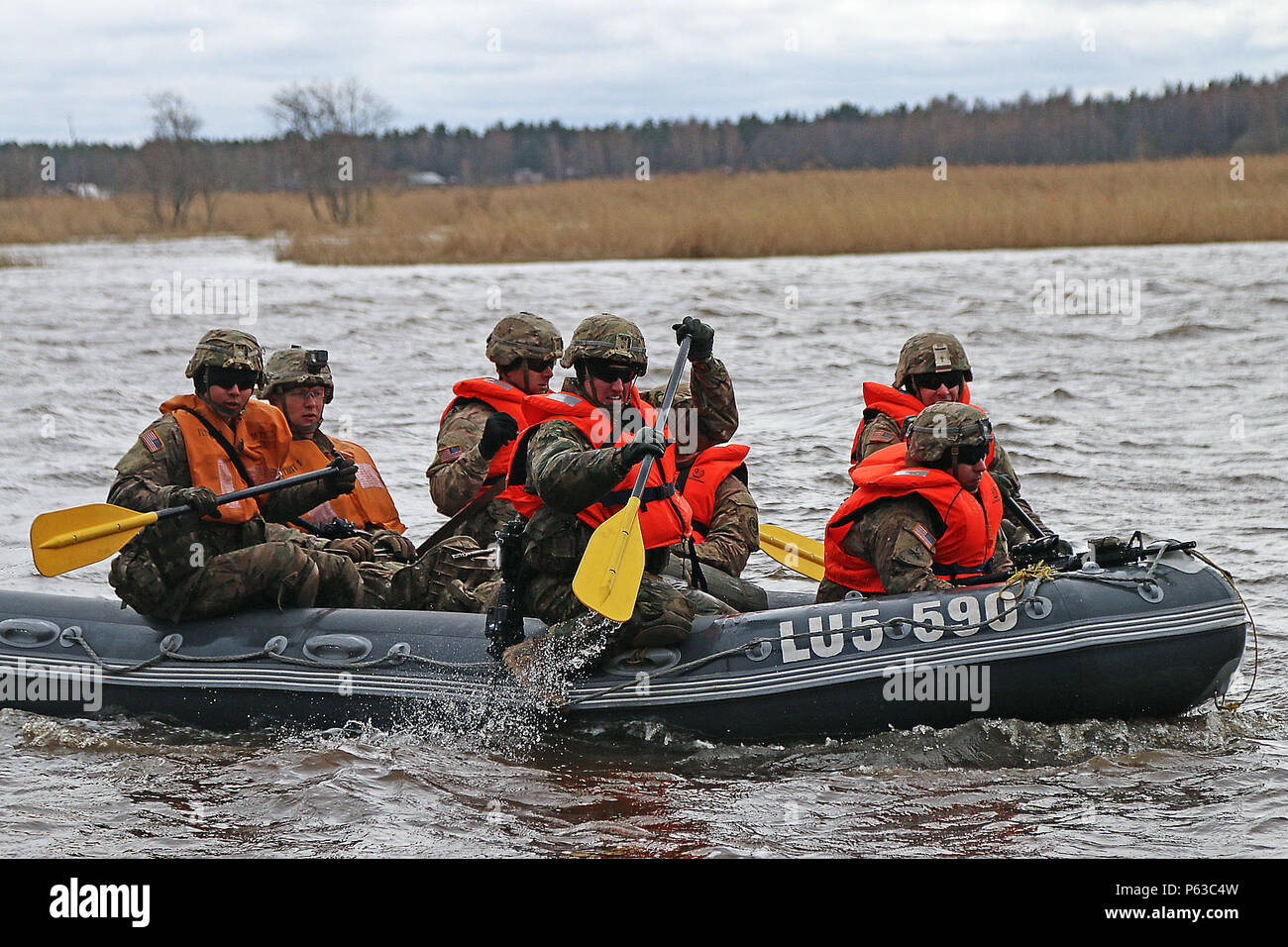 Spc. Michael Scollard (center), an infantryman assigned to Headquarters ...