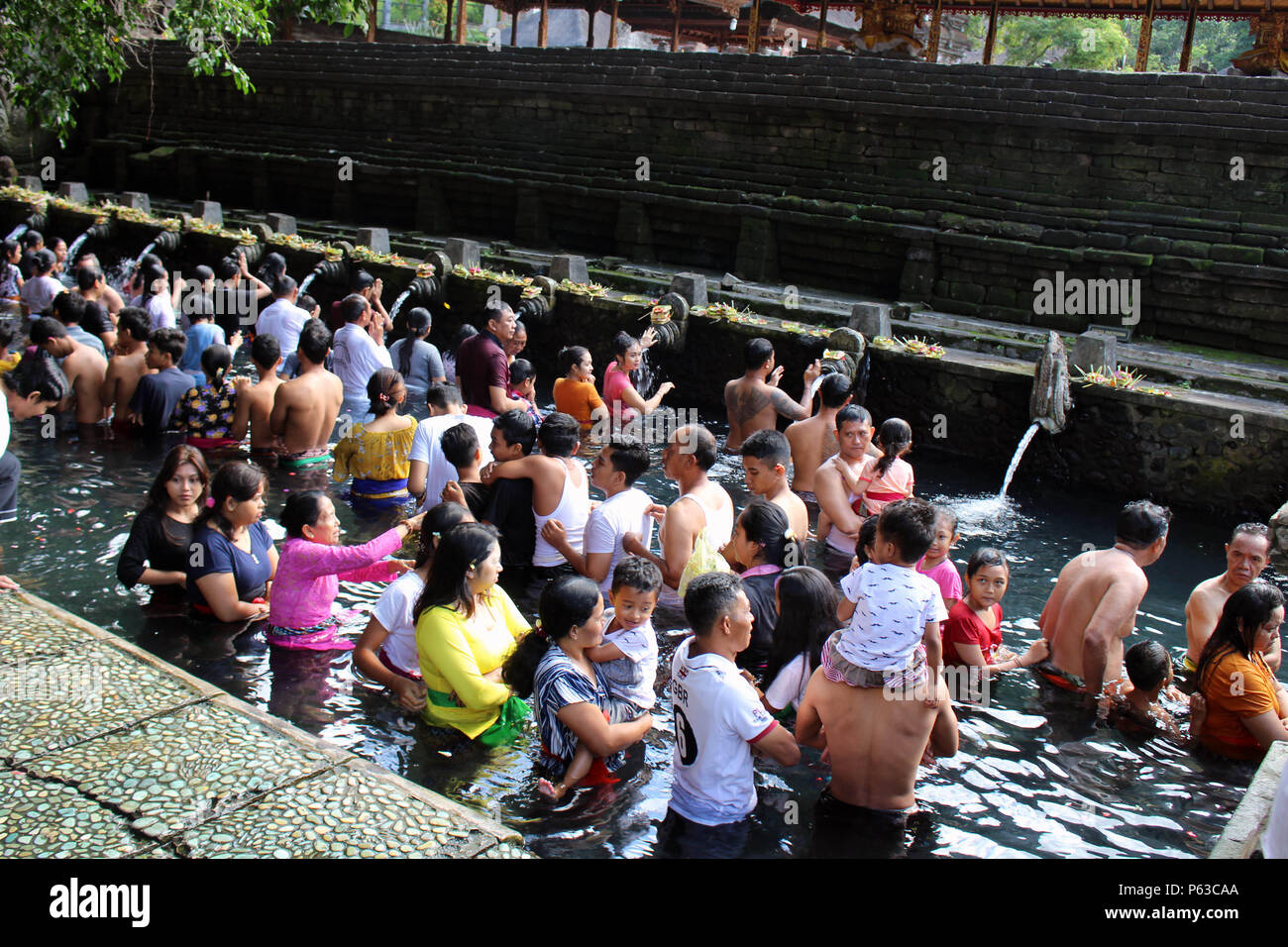 A flock of pilgrims purify their body and soul by taking bath at Pura ...