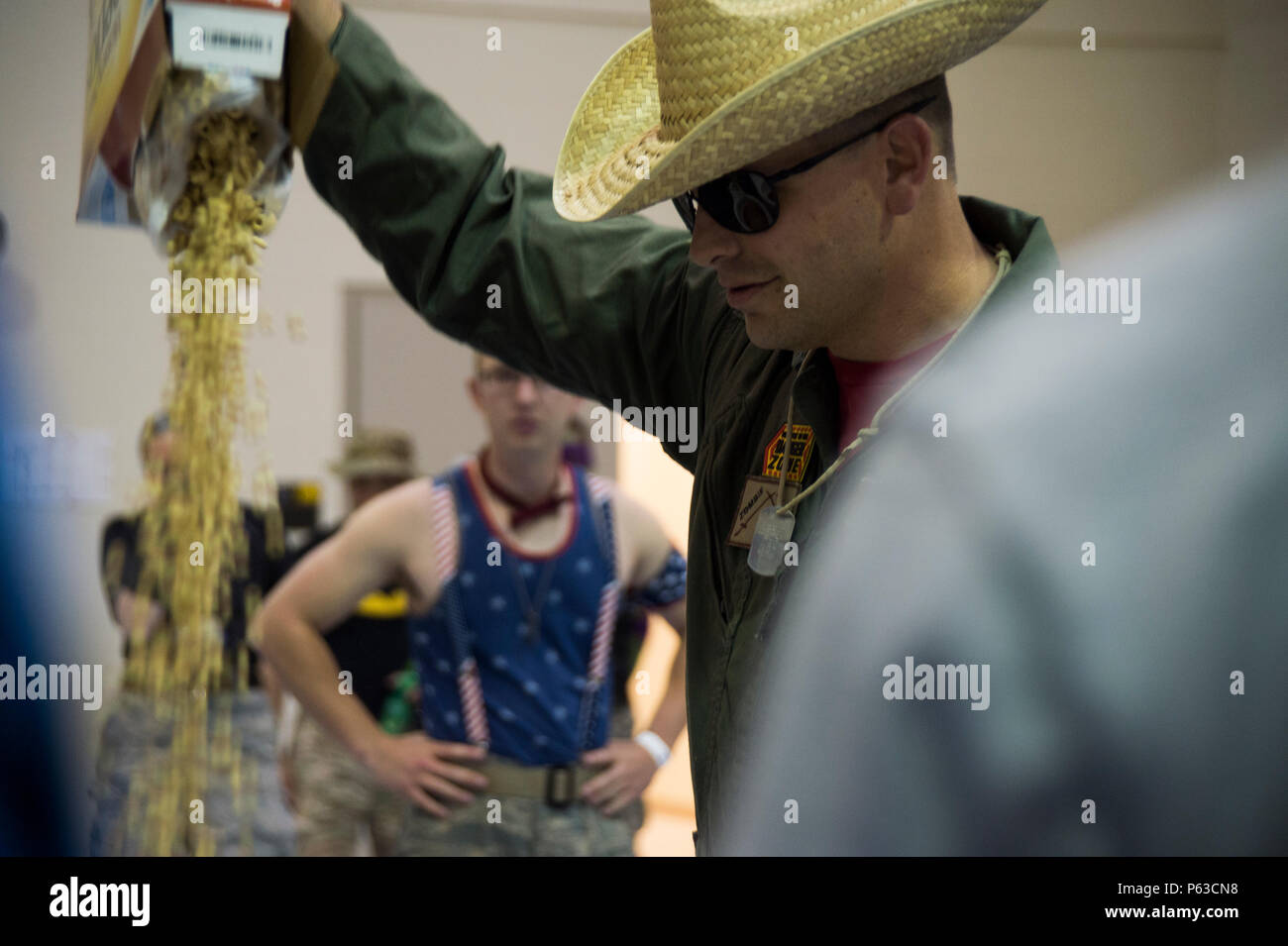 Maj. Rodney Lambert, 50th Contracting Squadron commander, pours ...