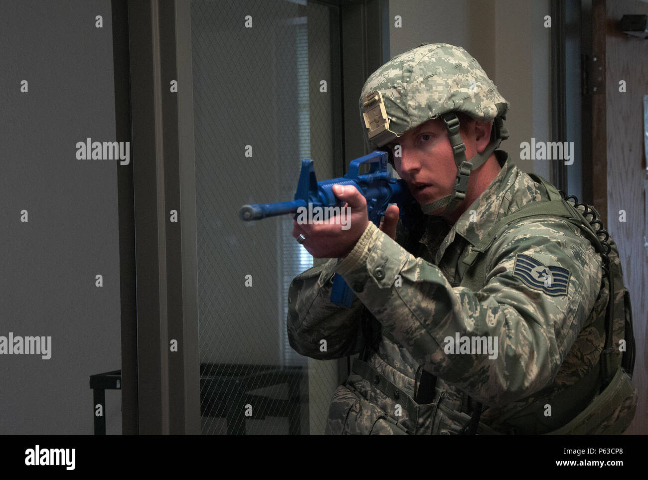 A 90th Security Forces Group technical sergeant keeps watch down a ...