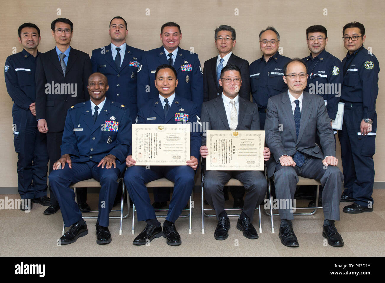 Members from the Tokyo Custom and 374th Security Forces Squadron pose ...