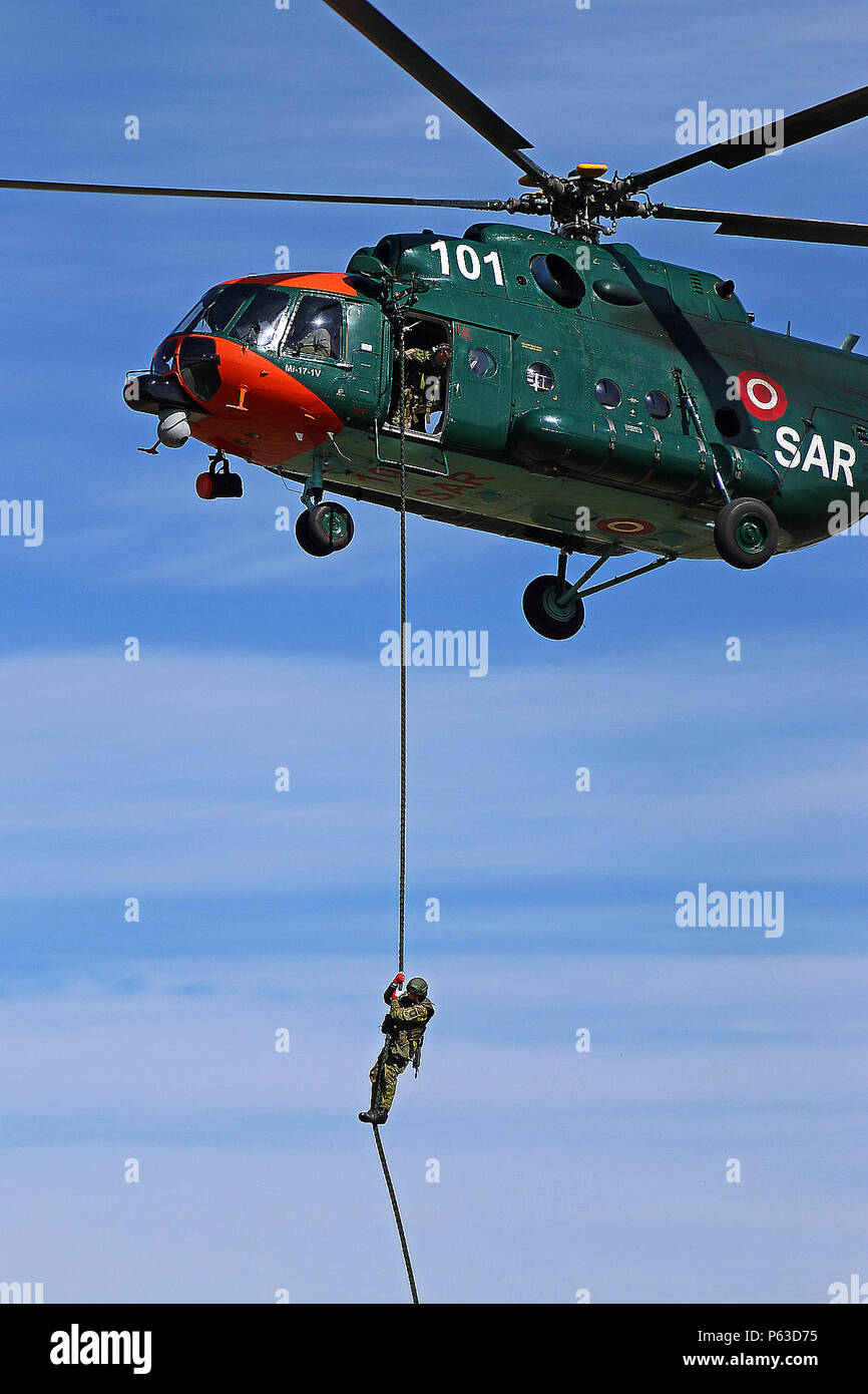 A Lithuanian soldier slides down a fast rope from a Latvian Mi-17 ...
