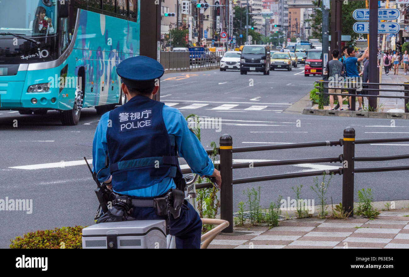 Japanese Police officer on a bicycle in the streets of Tokyo - TOKYO ...