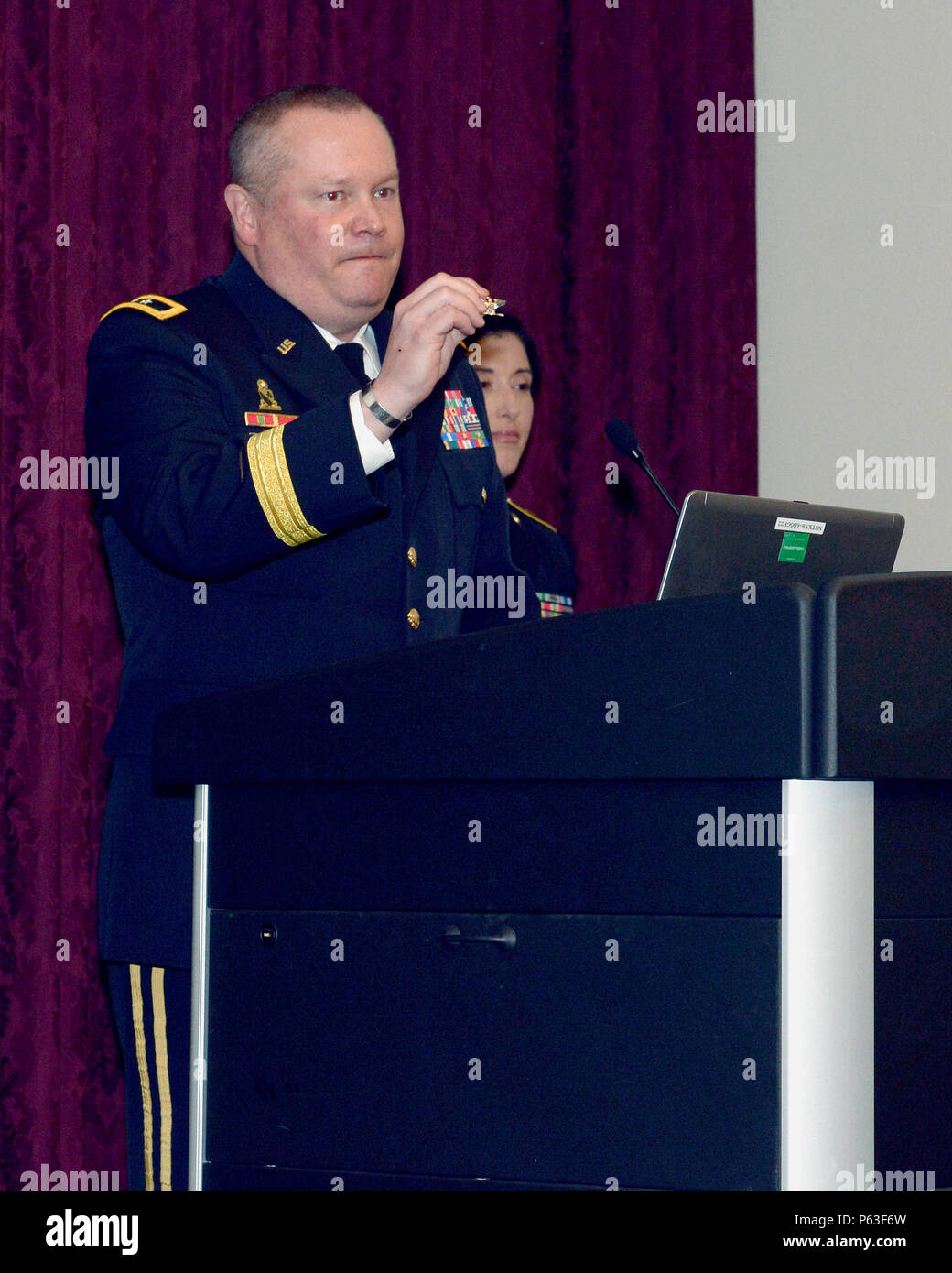 Maj. Gen. William "Len" Smith, deputy adjutant general - Army, holds up ...