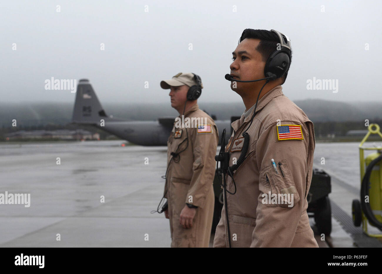 U.S. Air Force Technical Sergeant Gregory Flores (right), a loadmaster ...