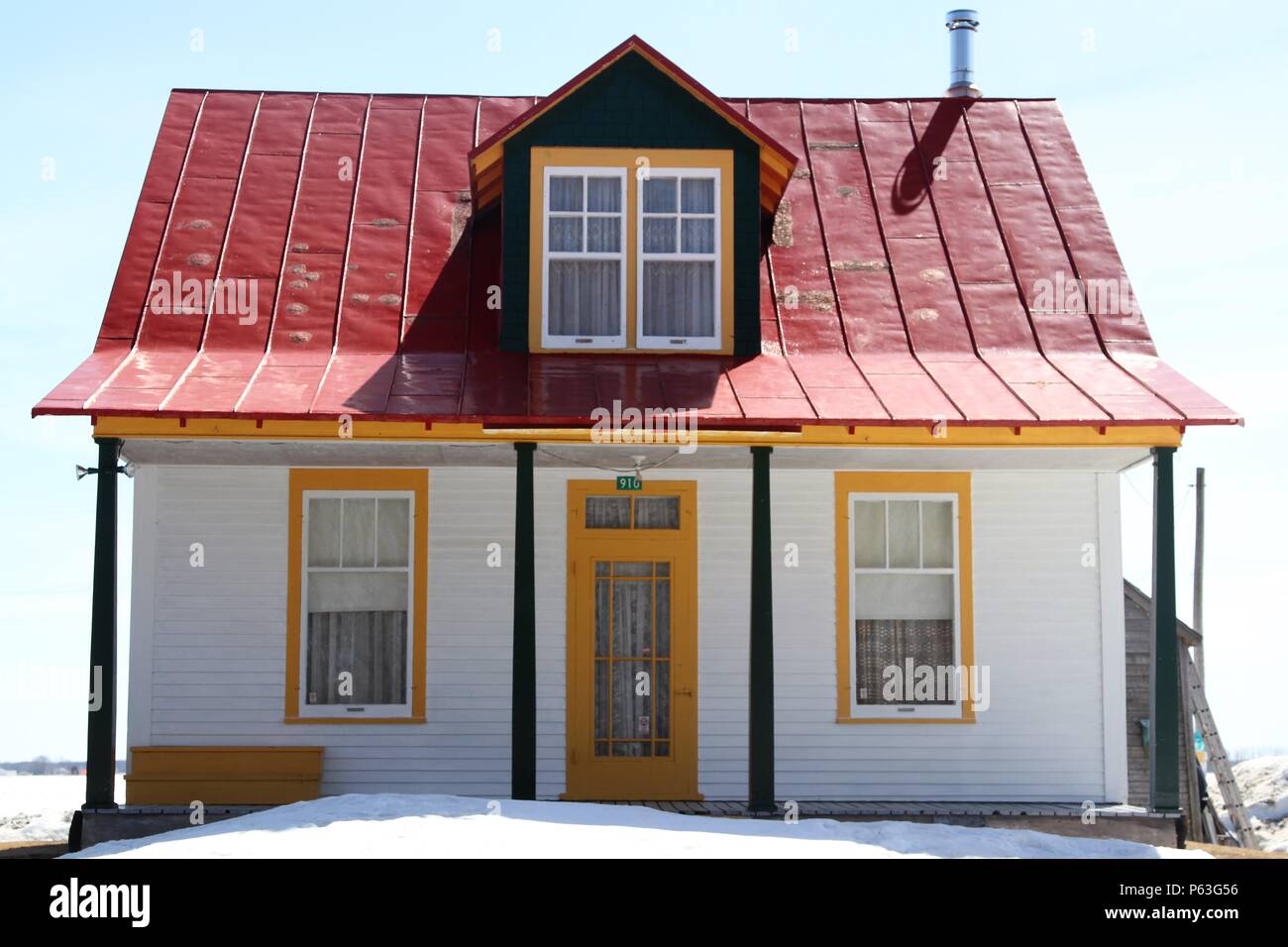 Vintage colorful french Canadian house with dormer above the door and ...
