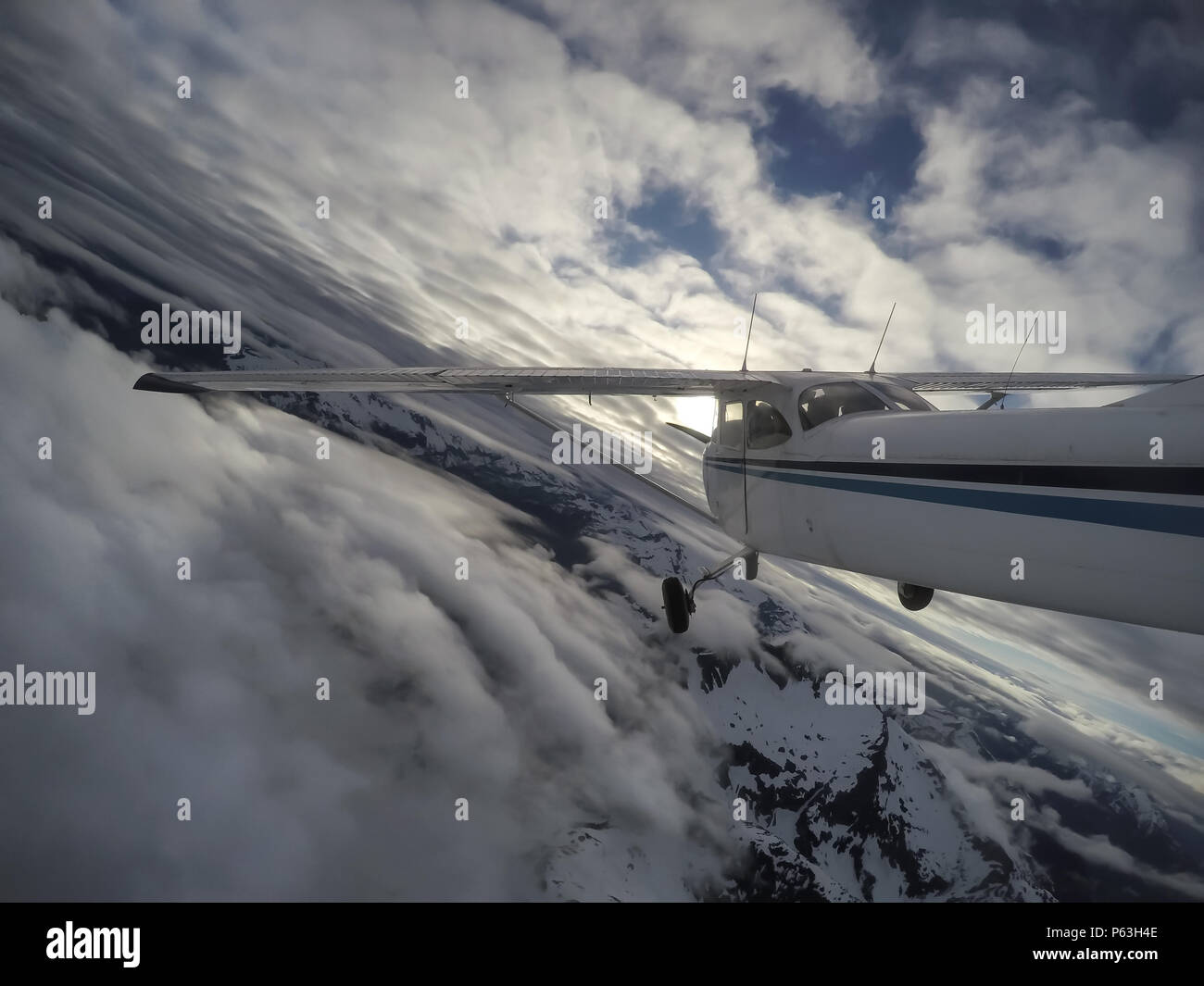 Airplane flying over the beautiful Canadian Mountain Landscape during a ...