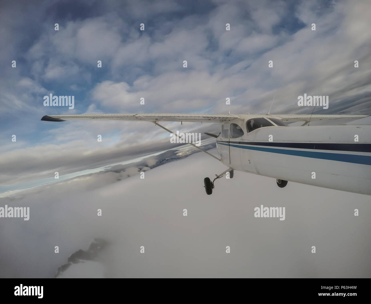 Airplane flying over the beautiful Canadian Mountain Landscape during a ...