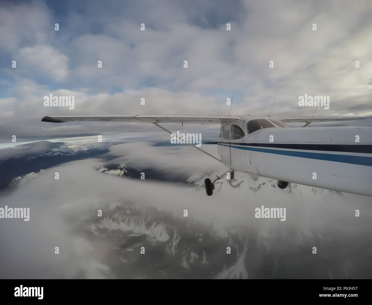 Airplane flying over the beautiful Canadian Mountain Landscape during a ...
