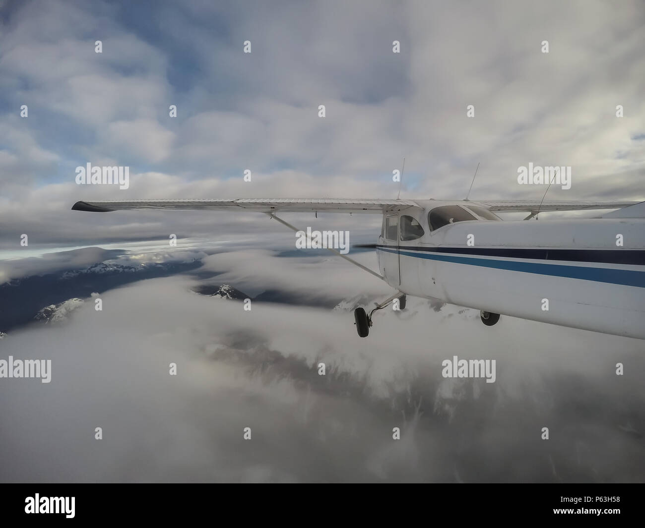 Airplane flying over the beautiful Canadian Mountain Landscape during a ...