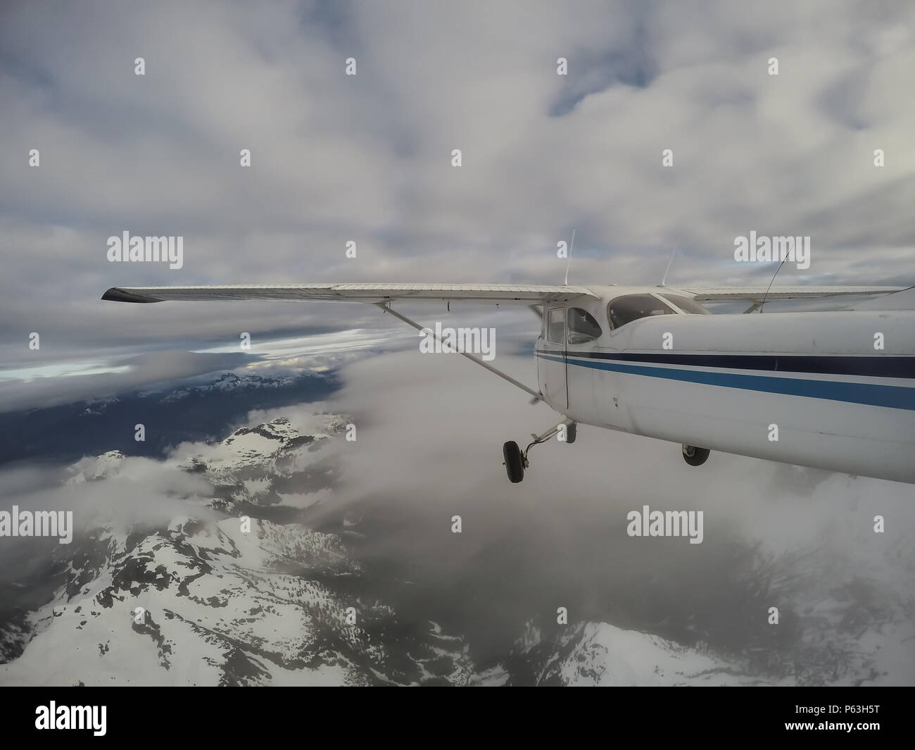 Airplane flying over the beautiful Canadian Mountain Landscape during a ...