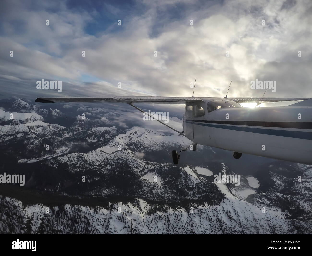 Airplane flying over the beautiful Canadian Mountain Landscape during a ...