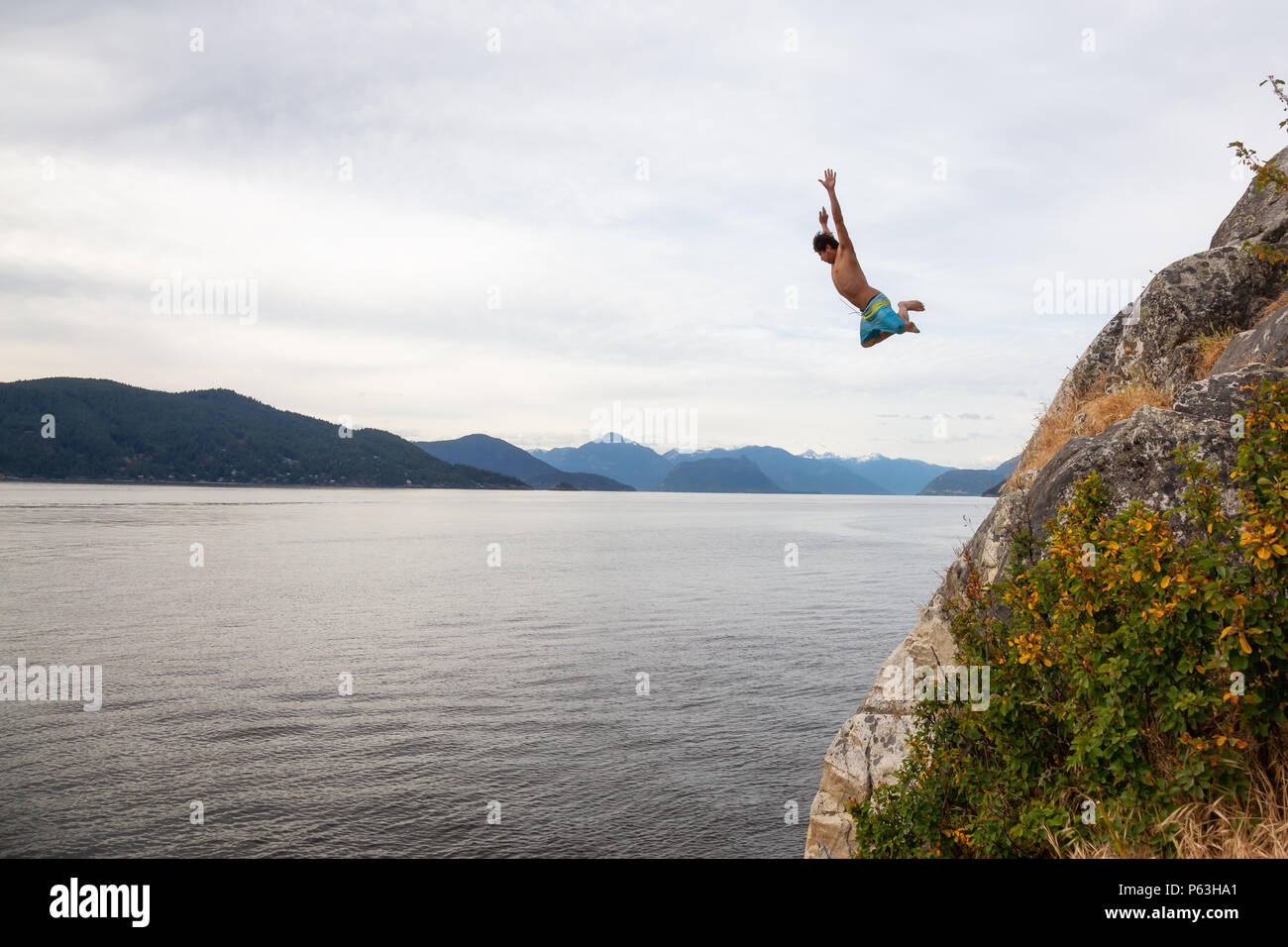 Man jumping rock coast hi-res stock photography and images - Alamy