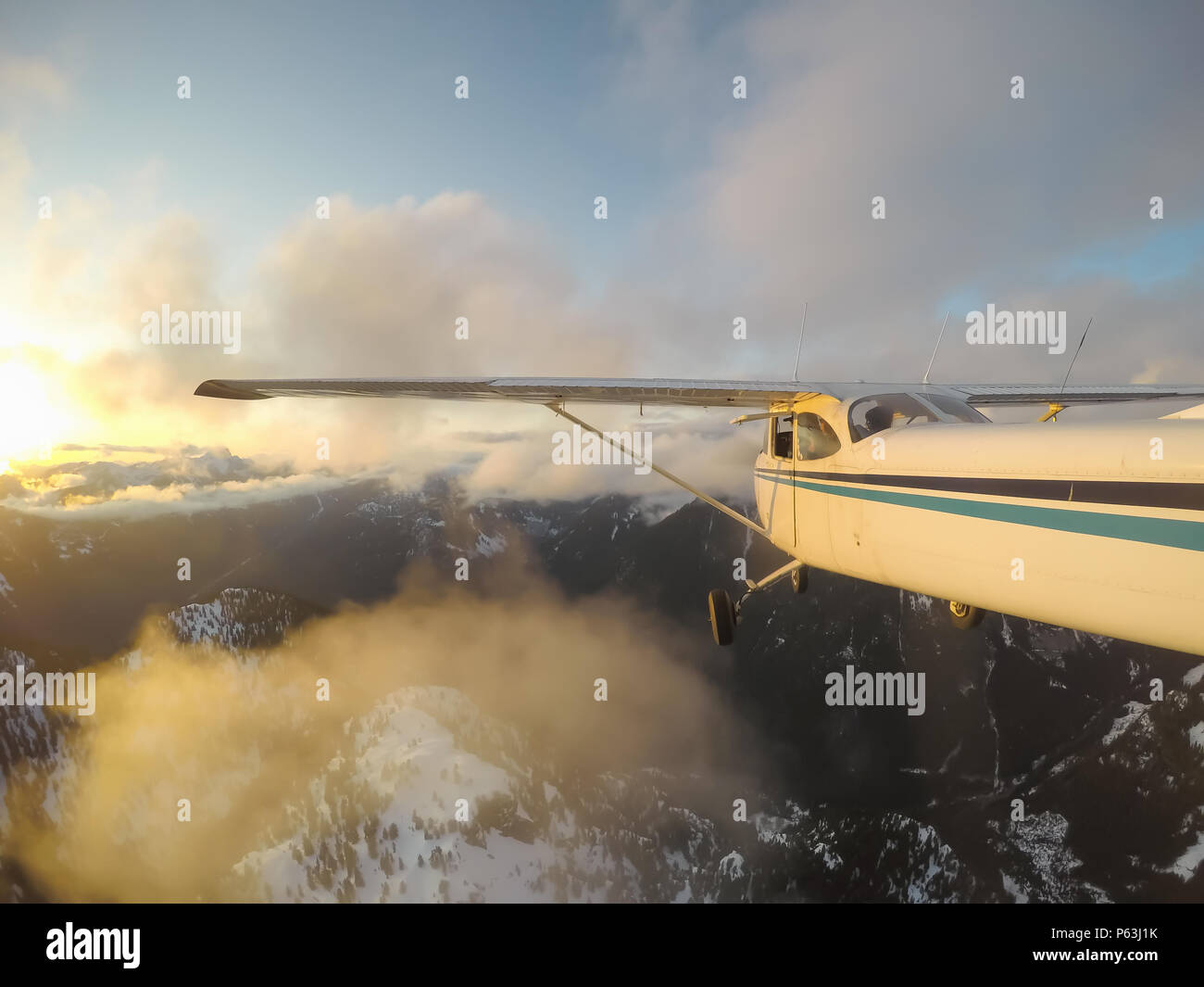 Airplane flying over the beautiful Canadian Landscape during a vibrant ...