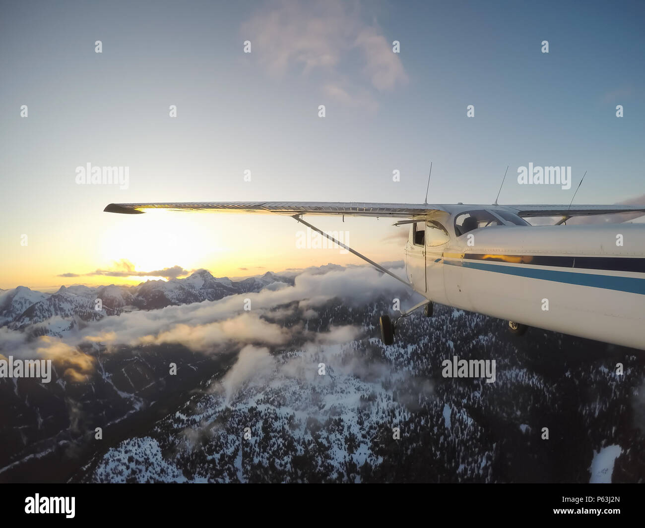 Airplane flying over the beautiful Canadian Landscape during a vibrant ...