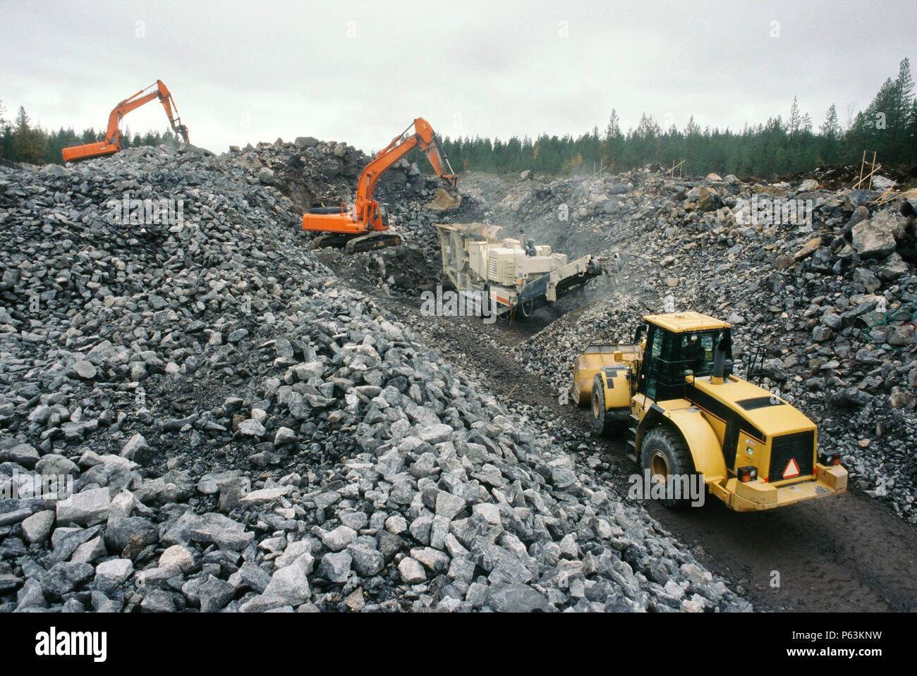Moving blasted rock for cutting on the line Stock Photo - Alamy
