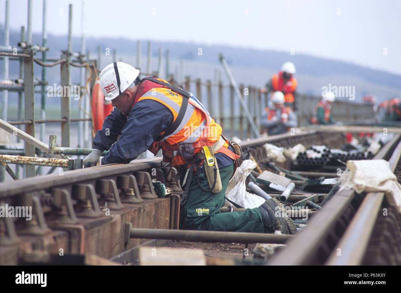 Assembling scaffolding for a railway bridge renovation project in north ...