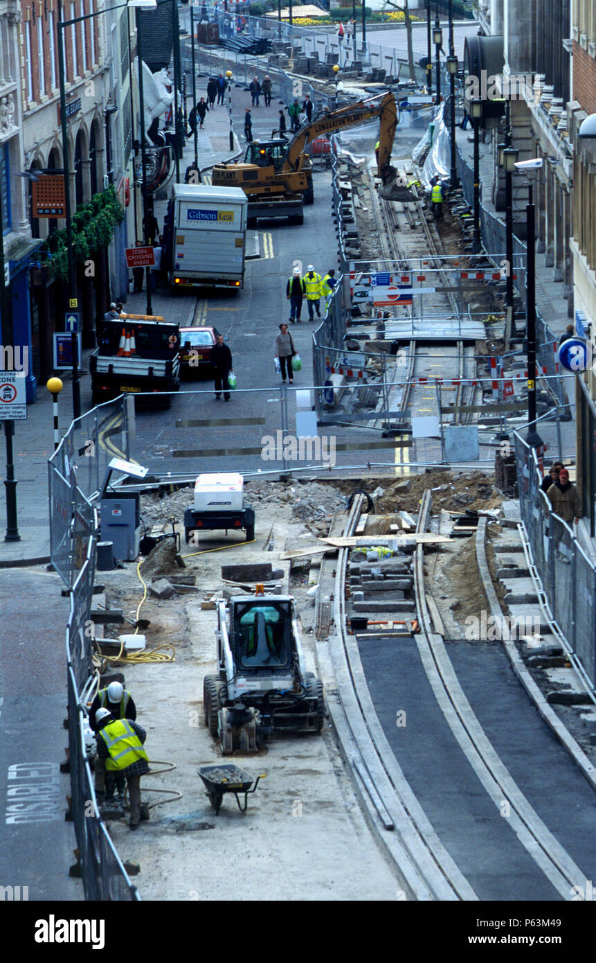Installation of track foundations along busy city centre street in ...