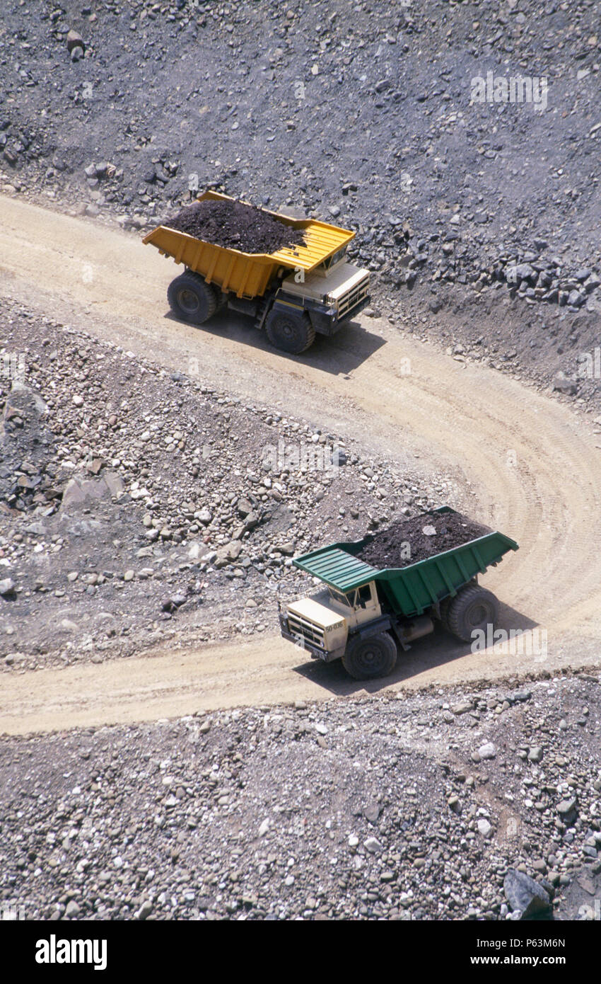 Russian made dump trucks carry fill material for a large earth fill ...