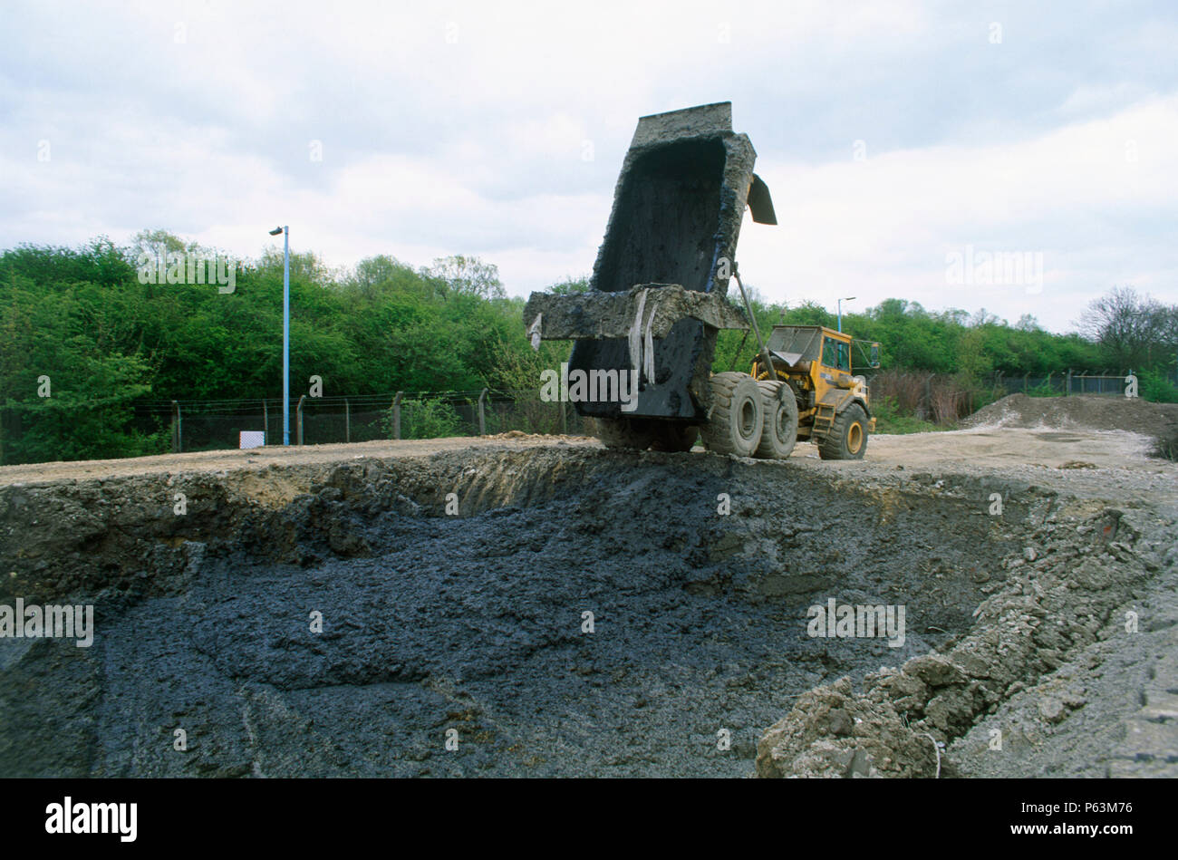Dump trailer used to transport sludge for disposal in a lagoon Stock ...
