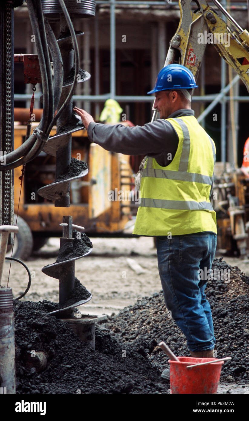 Mini piler removing a section of drill bit. Foundations for an office ...