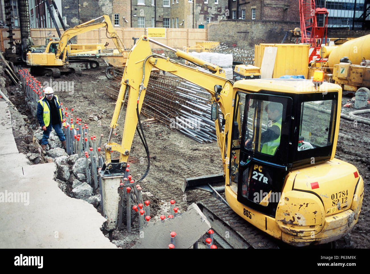 Breaking back the concrete tops of bored piles to expose the ...