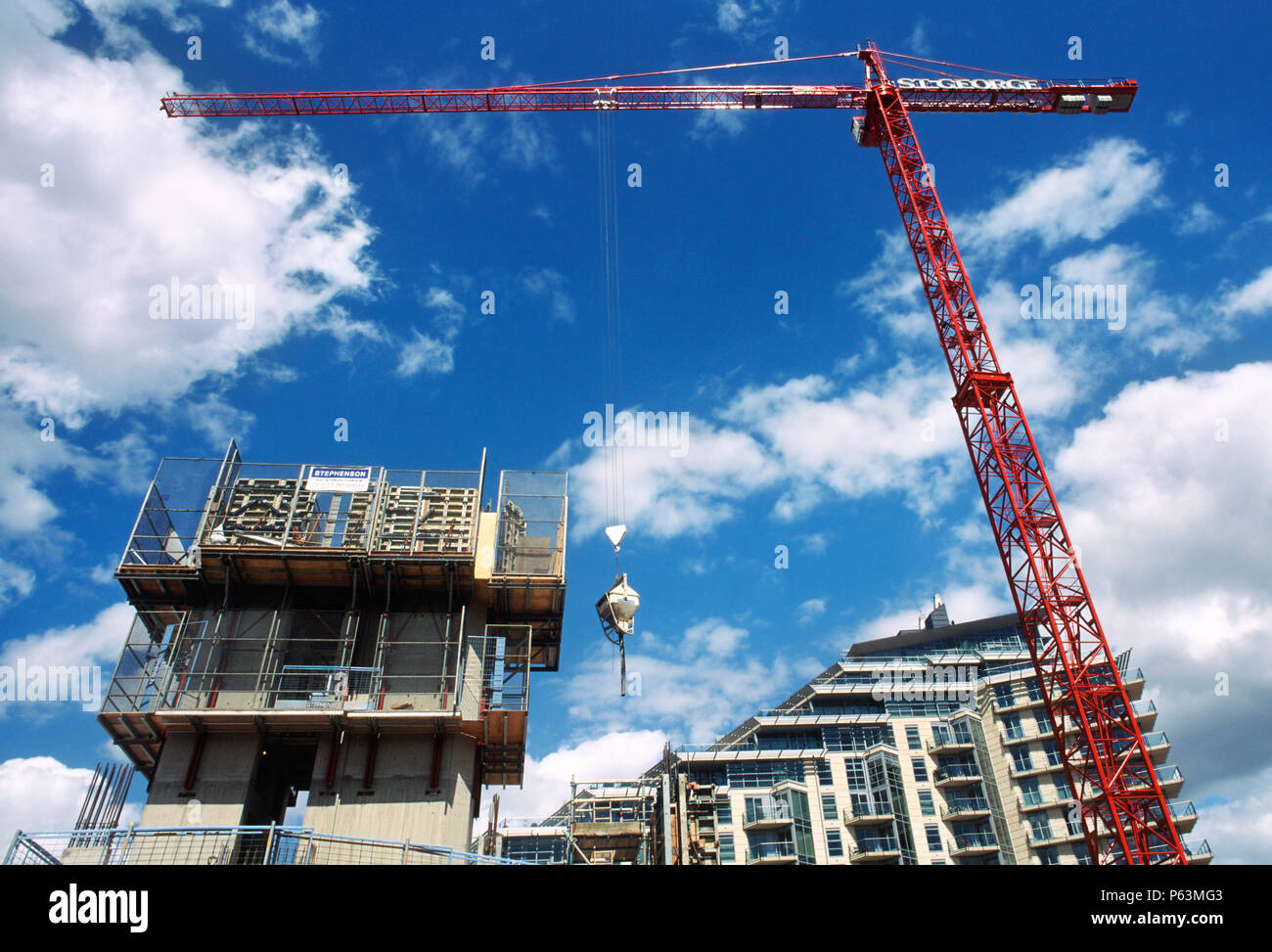 A tower crane lifts in concrete for a concrete core structure on new ...