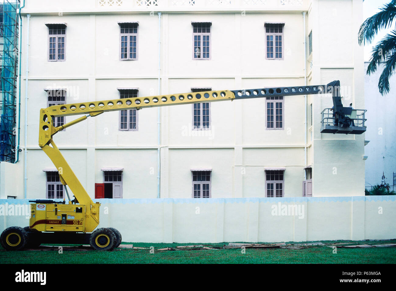 Working on a building facade from a platform in Singapore Stock Photo ...