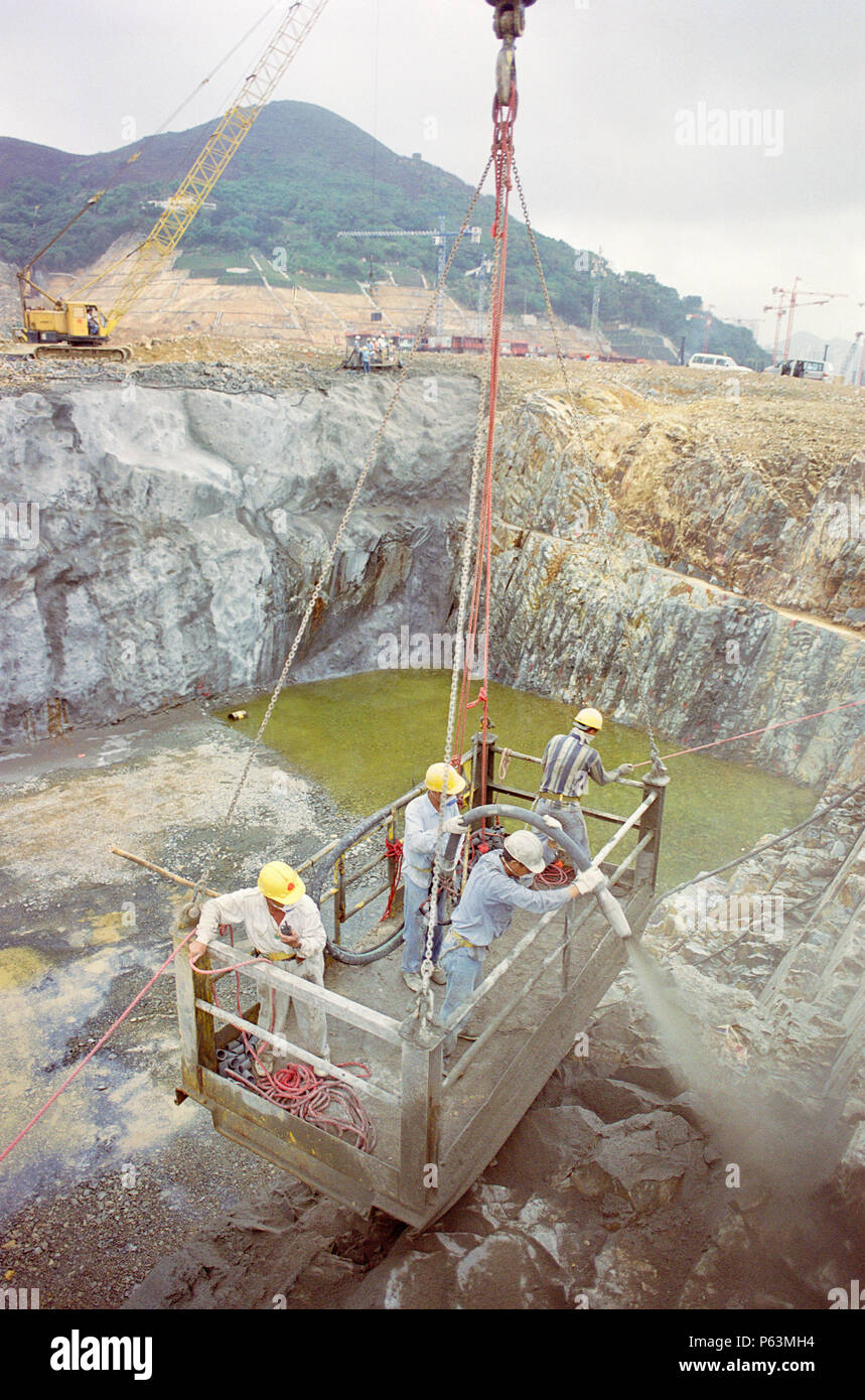 Shotcreting the face of a steep rock excavation for a tunnel approach ...