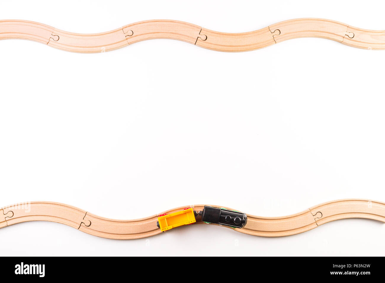 Toy train and curve wooden railways on white background Stock Photo - Alamy