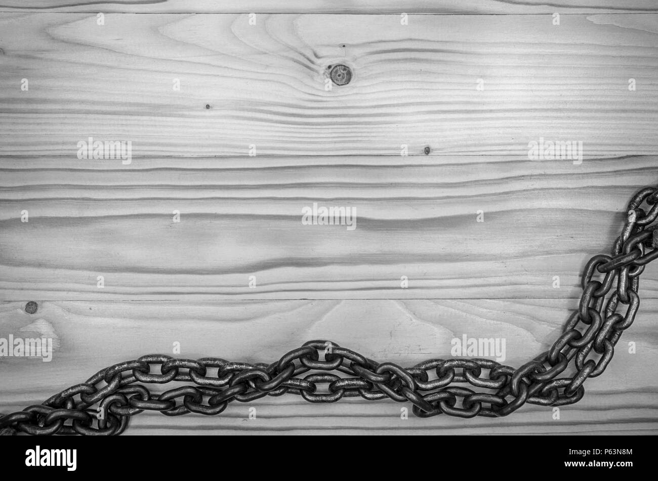 The steel chain on the wooden table is in black and white Stock Photo ...