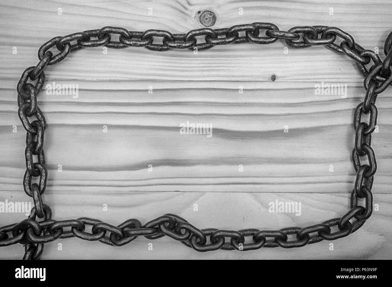 The steel chain on the wooden table is in black and white Stock Photo ...