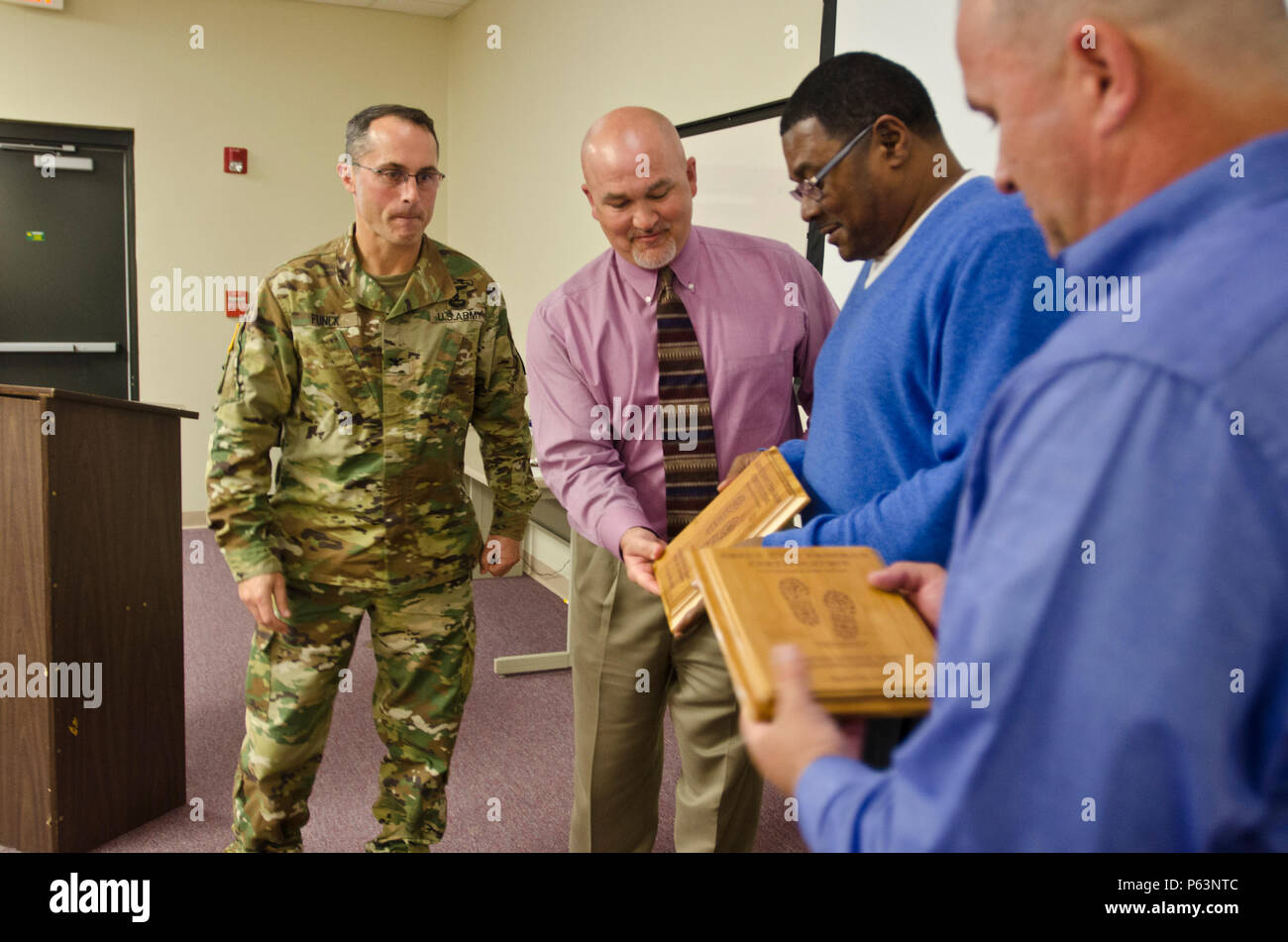 Col. Brett Funck, Fort Bragg Garrison Commander, presents Tony Jones, U ...