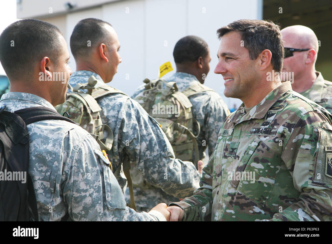 Col. John Haas, commander, 53rd Infantry Brigade Combat Team shakes the ...