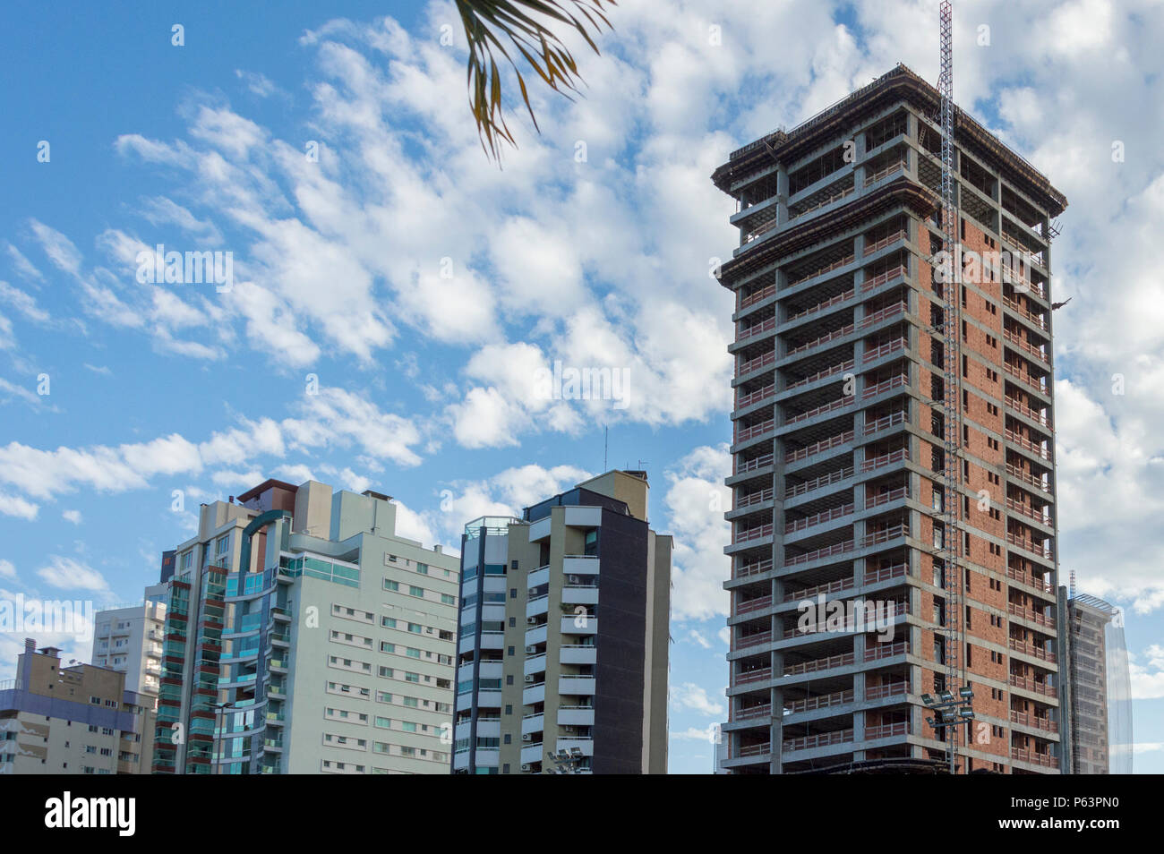 Facade of a skyscraper without windows, a floor surface on the sky ...