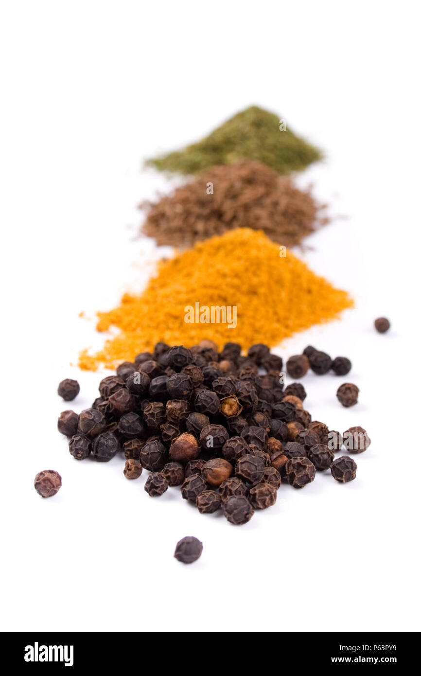 heapes of various spices on white background Stock Photo - Alamy